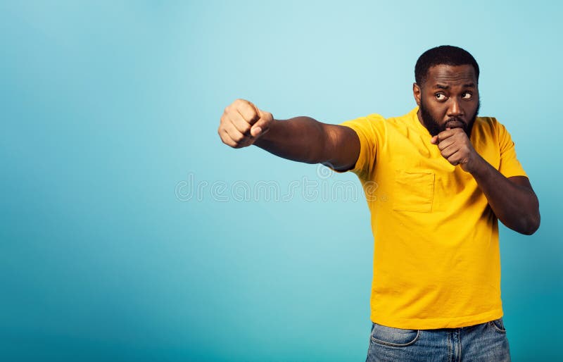 Angry Man Attacks with a Punch Something. Blue Background Stock Photo ...
