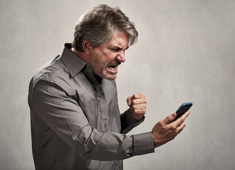 Angry man with cell phone. stock photo. Image of people - 84320972