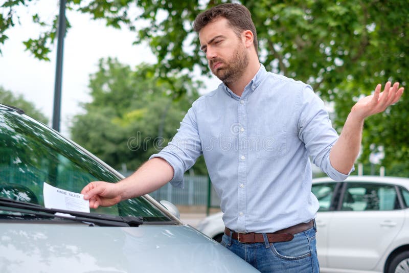 Angry Man Looking on Parking Ticket Placed Under Windshield Wiper Stock ...