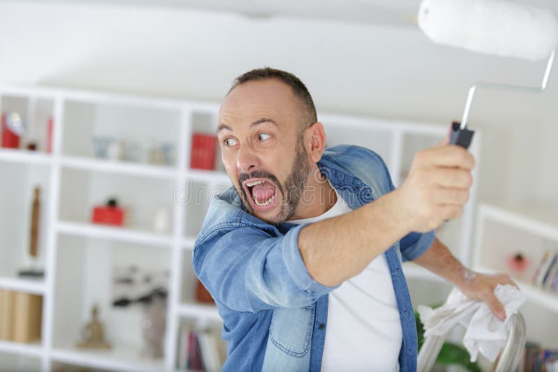Angry man while painting stock image. Image of occupation - 304133497