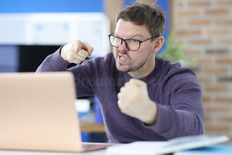 Angry Man Sits at Work Table in Front of Laptop Stock Image - Image of ...