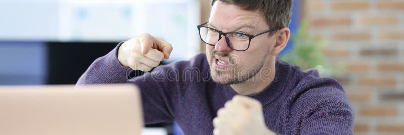 Angry Man Sits at Work Table in Front of Laptop Stock Photo - Image of ...