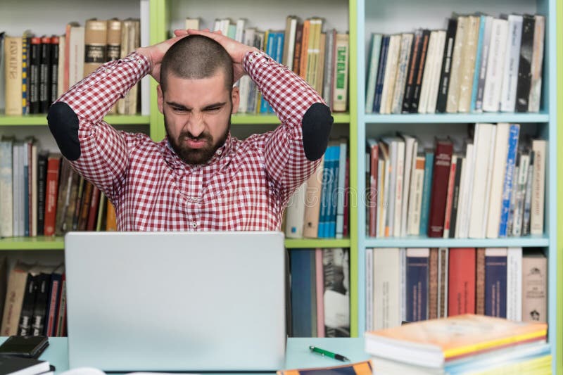 Angry Man Sitting at the Library Stock Photo - Image of stack, desk ...