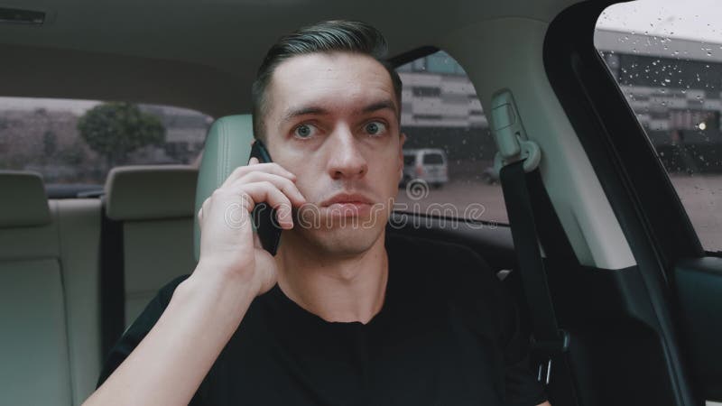 Angry Man Talking on the Phone while Sitting in the Car. Aggressive ...