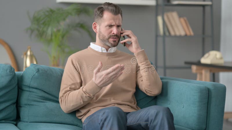 Angry Man Talking on Phone on Sofa Stock Image - Image of anger, voice ...