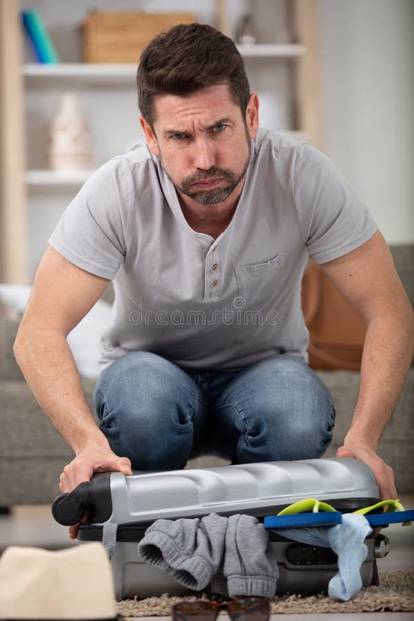 Angry Man Tries To Packing Suitcase Stock Photo - Image of hotel, messy ...
