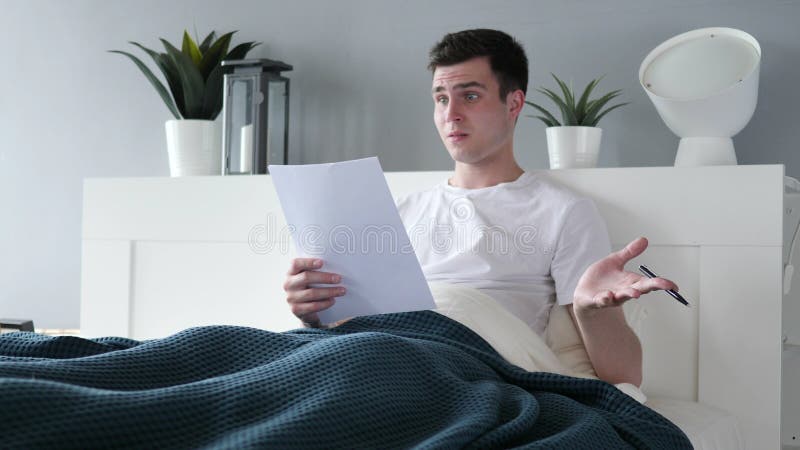 Angry Man Upset after Reading Documents in Bed Stock Image - Image of ...
