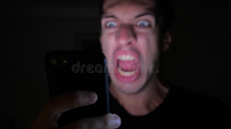 Angry Man Using Smartphone at Night. Furious Yelling Man with ...
