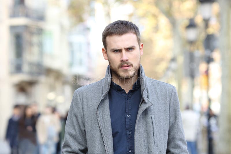 Angry Man Walking in the Street Looking at Camera Stock Image - Image ...