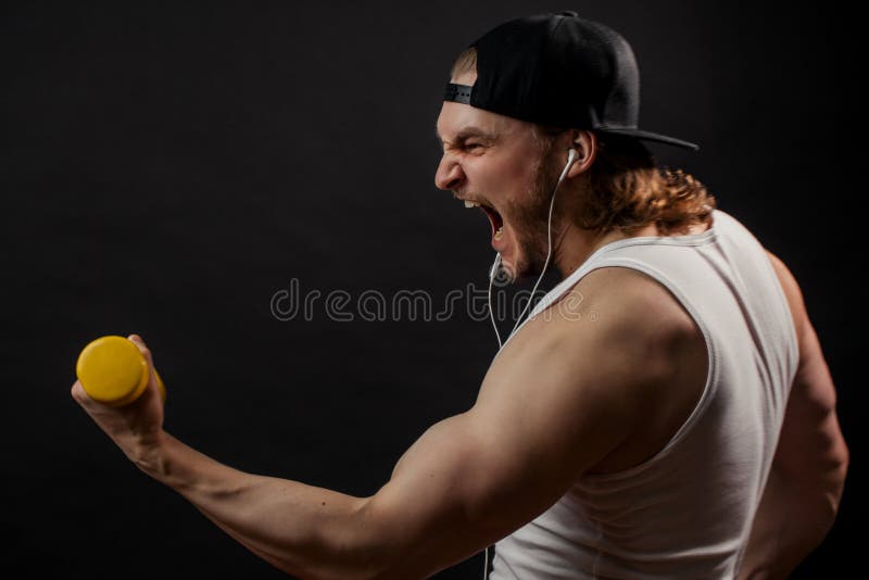 Angry Muscular Man is Training with Dumbbell Stock Photo - Image of ...