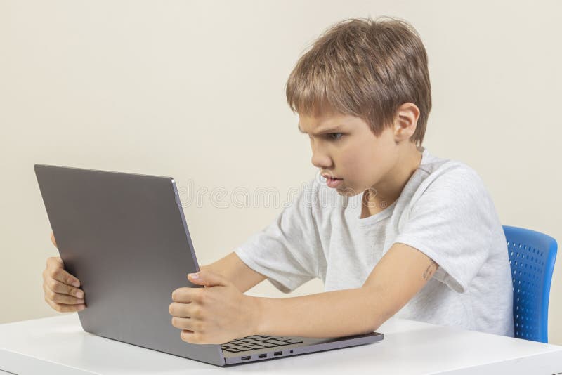 Angry Sad Boy with Laptop Computer Sitting at the Table Stock Image ...