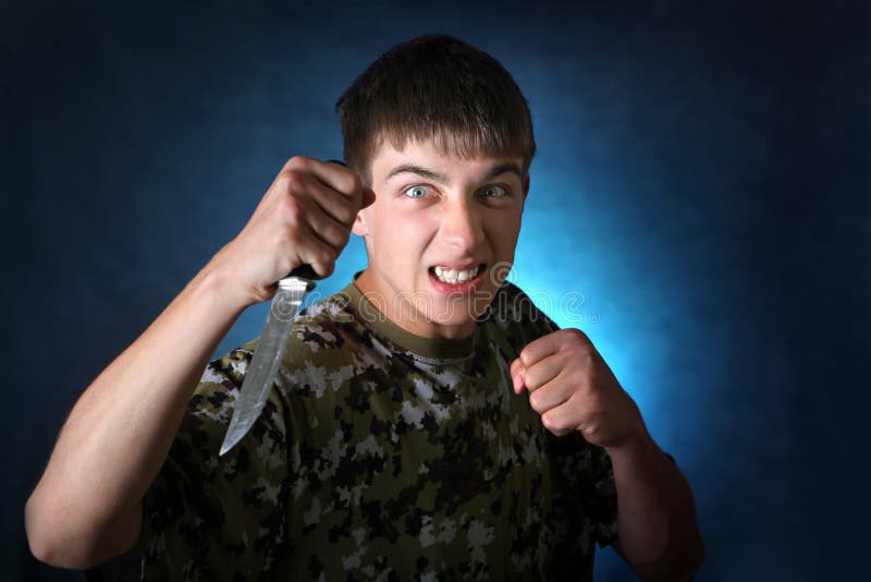 Angry Teenager with Knife stock photo. Image of indoor - 34535316