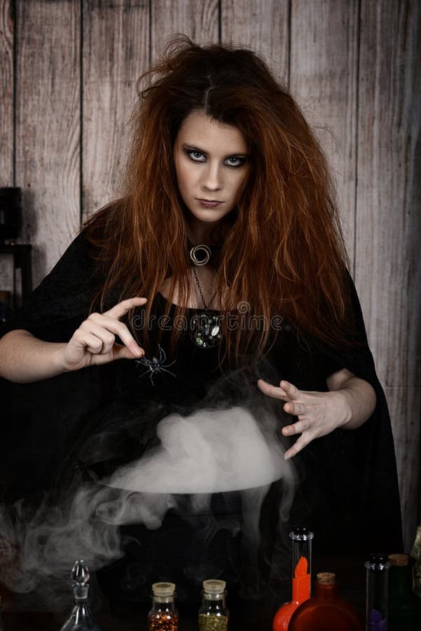 Witch Pouring Poison into Her Magic Potion with Skull in Fog Stock ...