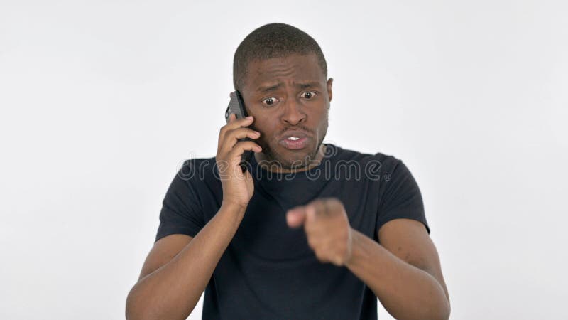 Angry Young African Man Talking on Phone on White Background Stock ...