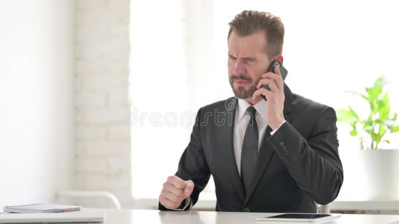 Angry Young Businessman Talking on Phone Stock Image - Image of adult ...