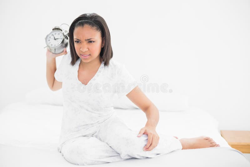 Angry Young Dark Haired Model Throwing an Alarm Clock Stock Image ...