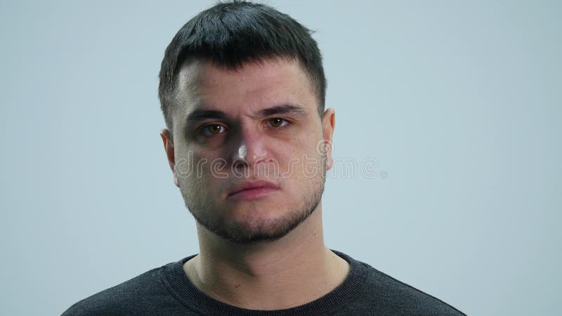 Angry Young Handsome Man Looking at Camera Over White Background Stock ...