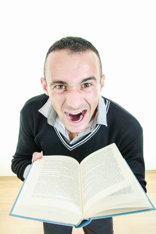Angry Young Man Holding a Book Tired of Reading Stock Photo - Image of ...