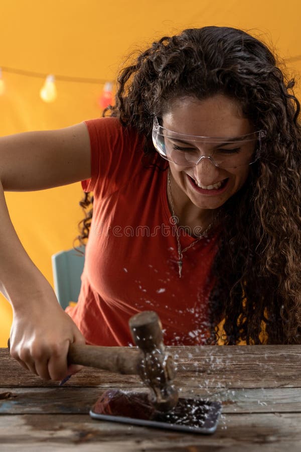 Angry Young Woman Breaking a Smartphone with a Hammer Stock Photo ...
