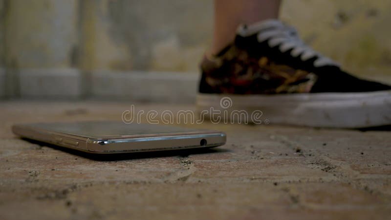 Angry Young Woman Steps on a Smartphone Under Her Shoe Stock Video ...