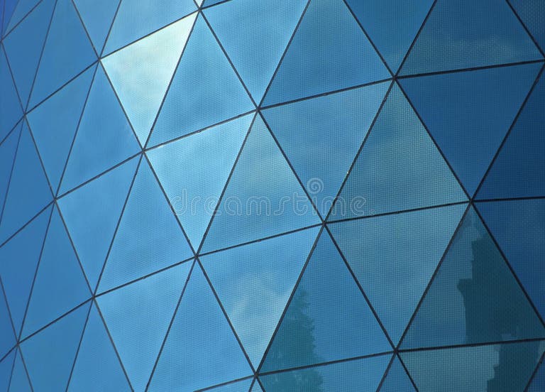 Angular Patterned Mirrored Windows Panes Reflecting the Sky and Clouds ...