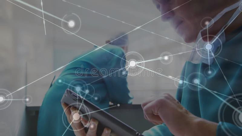 Animation of Connections Over Caucasian Male Surgeon Using Tablet in ...