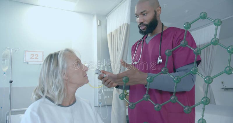Animation of Element Structure Over Diverse Male Doctor Checking Ear of ... Animation of Element Structure Over Diverse Male Doctor Checking Ear of ...