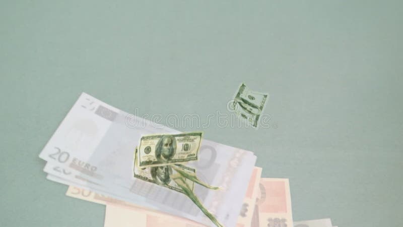 Animation of Falling Dollar Bills Over Euro on Table Against Abstract ...