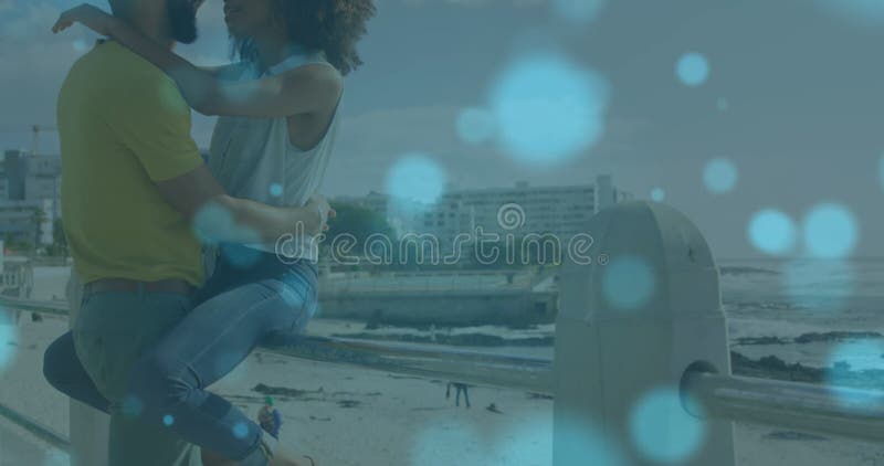 Animation of Light Spots Over African American Couple Embracing at ... Animation of Light Spots Over African American Couple Embracing at ...