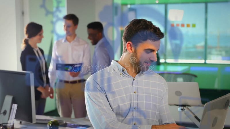 Animation of Multiple Digital Icons Over Caucasian Man Using Laptop and ...