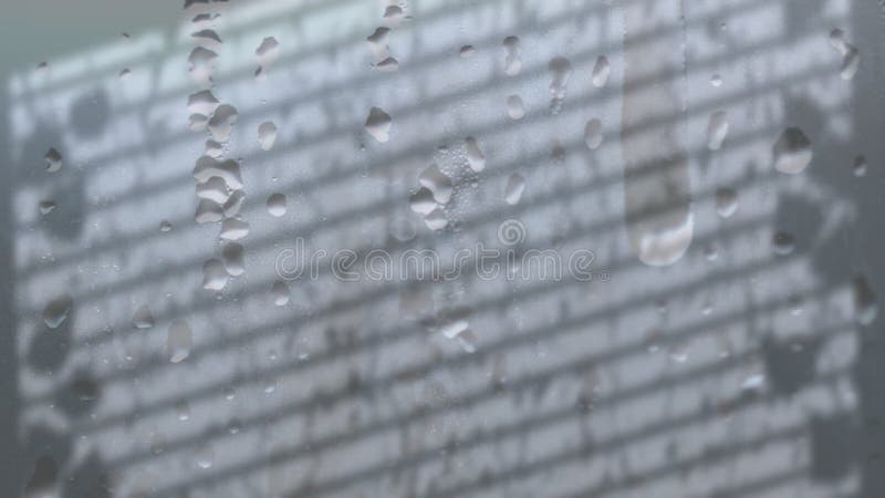 Animation of Raindrops Over Window Shadow on Grey Background Stock ...