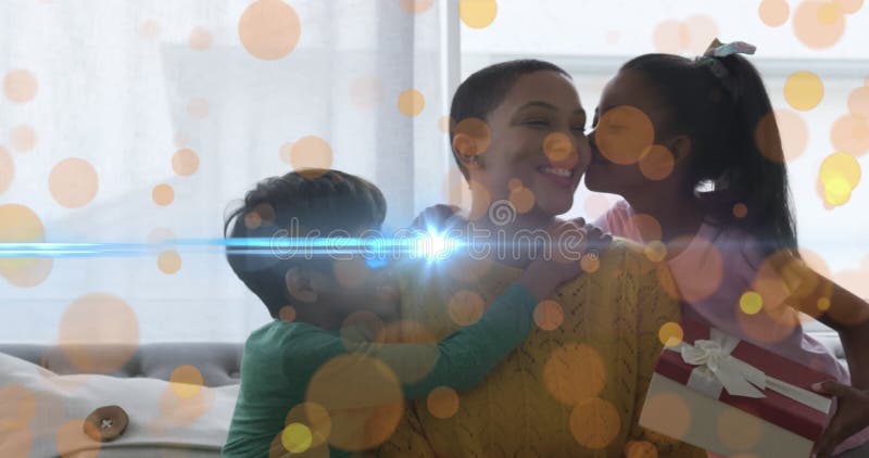 Animation of Spots Over African American Mother with Children Smiling ... Animation of Spots Over African American Mother with Children Smiling ...