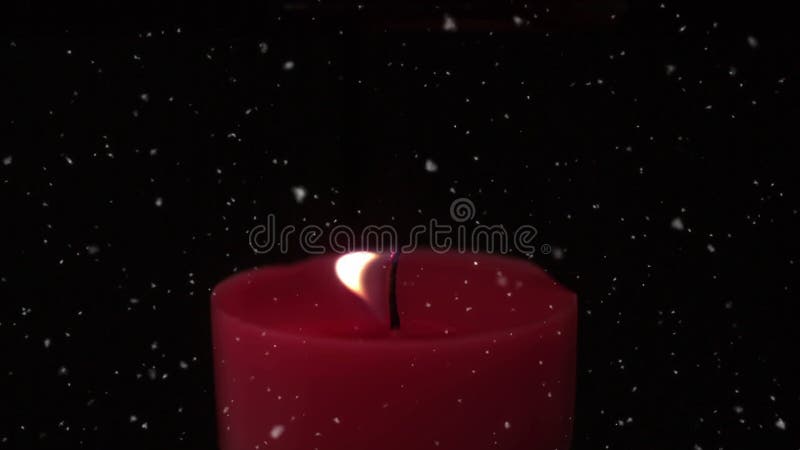 Animation of White Particles Falling Over Red Lit Candle on Dark ...