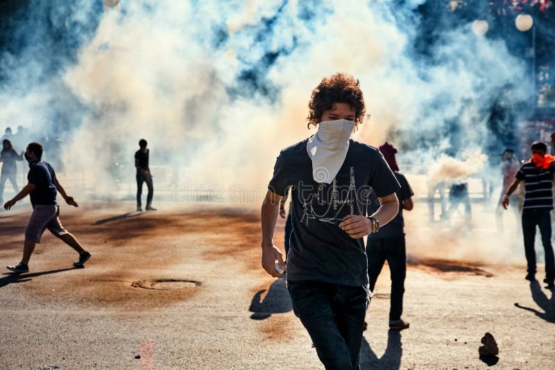Male Protester Running Away from the Tear Gas Smoke Fired by the Police ... Male Protester Running Away from the Tear Gas Smoke Fired by the Police ...
