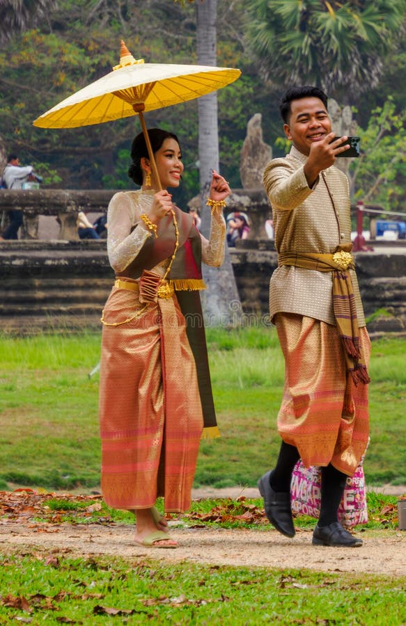 A Couple Dressed in Traditional Cambodian Clothiers Stroll at Agnkor ...