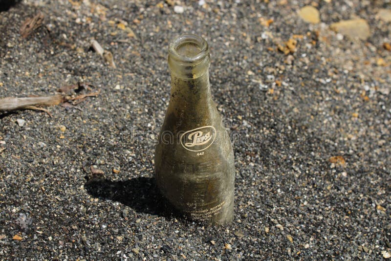 Old Glass Pepsi Bottle in the Sand Editorial Photography - Image of ...