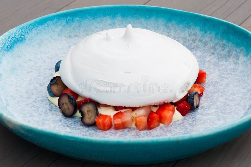 Anna Pavlova Dessert with Berries in a Blue Plate Stock Image - Image ...