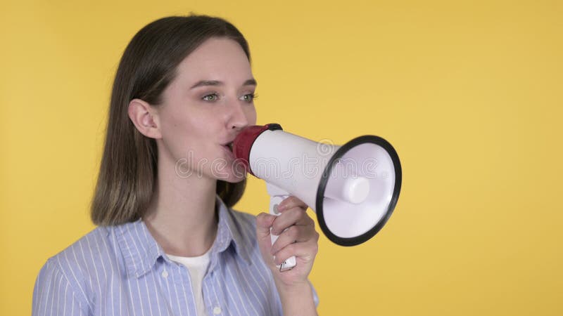 Announcing Young Woman Shouting through Megaphone, Yellow Background ...