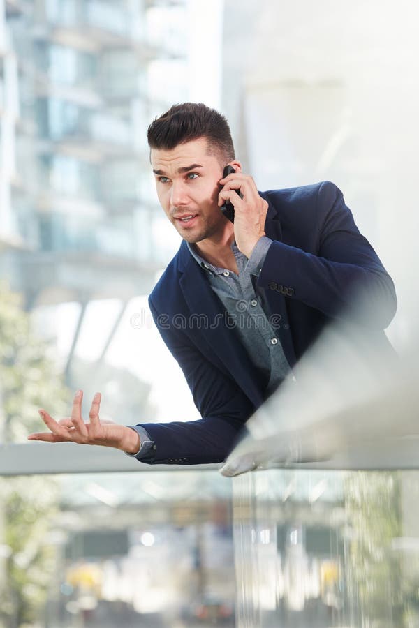 Smiling Business Man Talking on Mobile Phone in the City Stock Image ...
