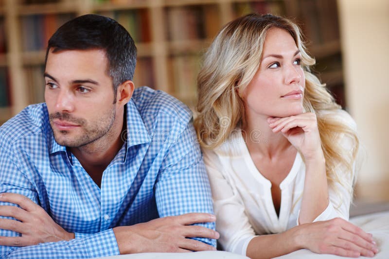 Annoyed Married And Couple With Argument At Home In Lounge Together
