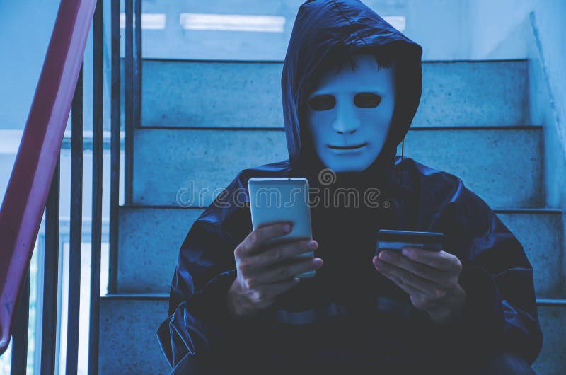 Anonymous Computer Hacker in White Mask and Hoodie, Hacker Holding ...