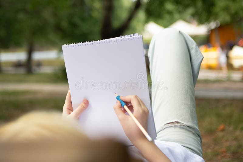 Anonymous Girl Making Notes or Drawing in the Blank Paper Book Stock ...