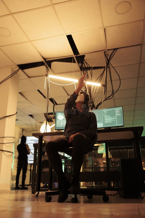 Anonymous Hacker Coding Malware in Ar, Making Hand Gesture Stock Photo ...