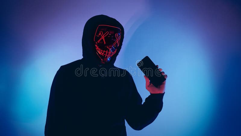 Anonymous Hacker and Face Mask with Smartphone in Hand Stock Image ...
