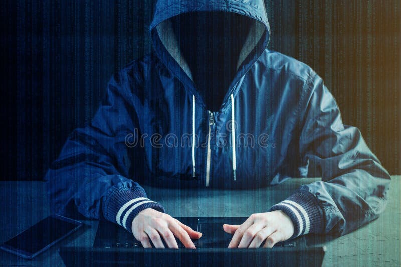Anonymous Hacker Programmer Uses a Laptop To Hack the System in the Dark. Concept of Cybercrime ...