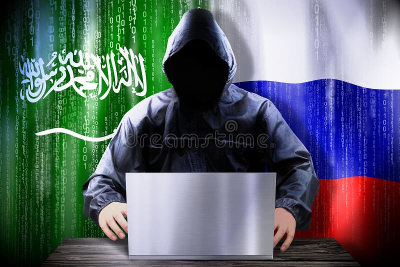 Anonymous Hacker Working on a Laptop, Flags of Saudi Arabia and Russia ...
