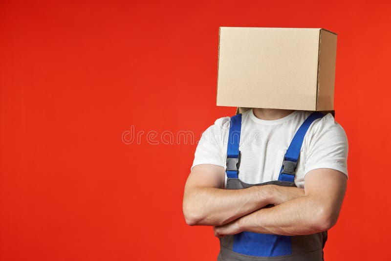 Anonymous Loader in a Work Suit on a Red Background with a Box on His ...