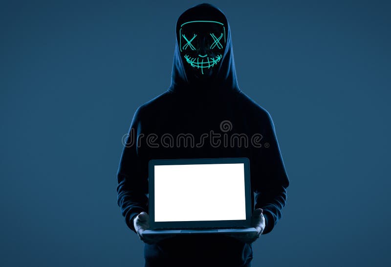 Anonymous Man in a Black Hoodie and Neon Mask Hacking into a Computer ...