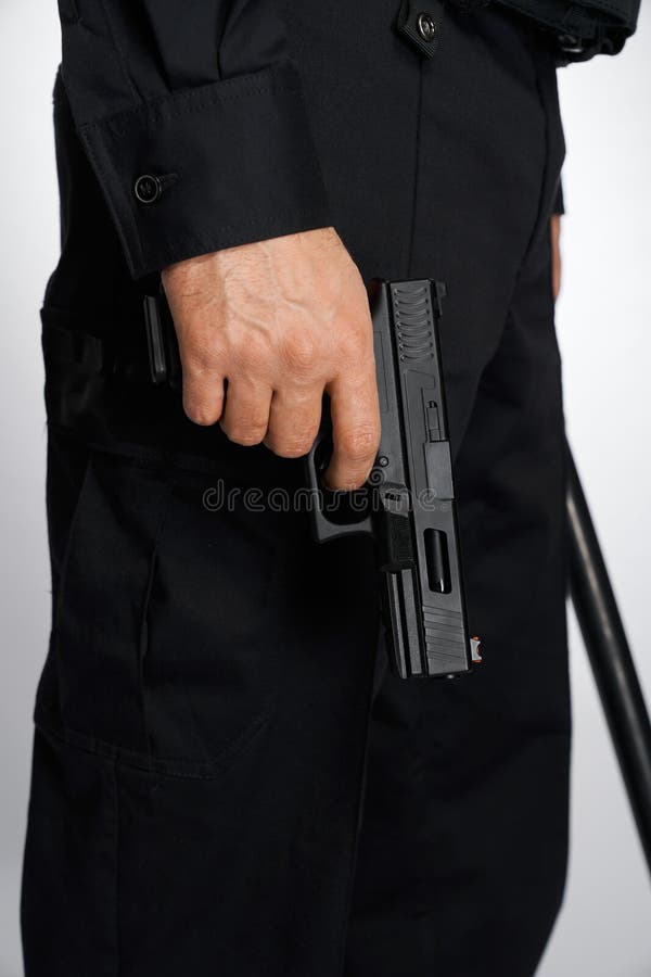 Anonymous Man in Uniform Carrying Handgun, Firearm, with Forefinger on ...