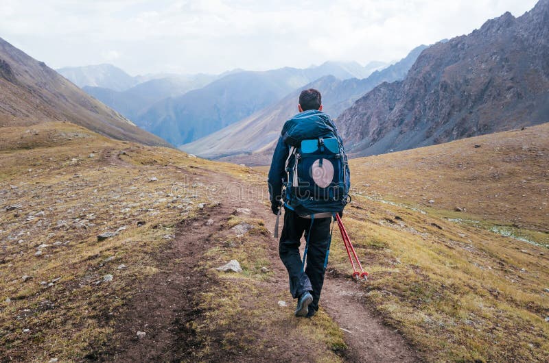 Man Walking Along a Mountain Trail Stock Photo - Image of adventure ...